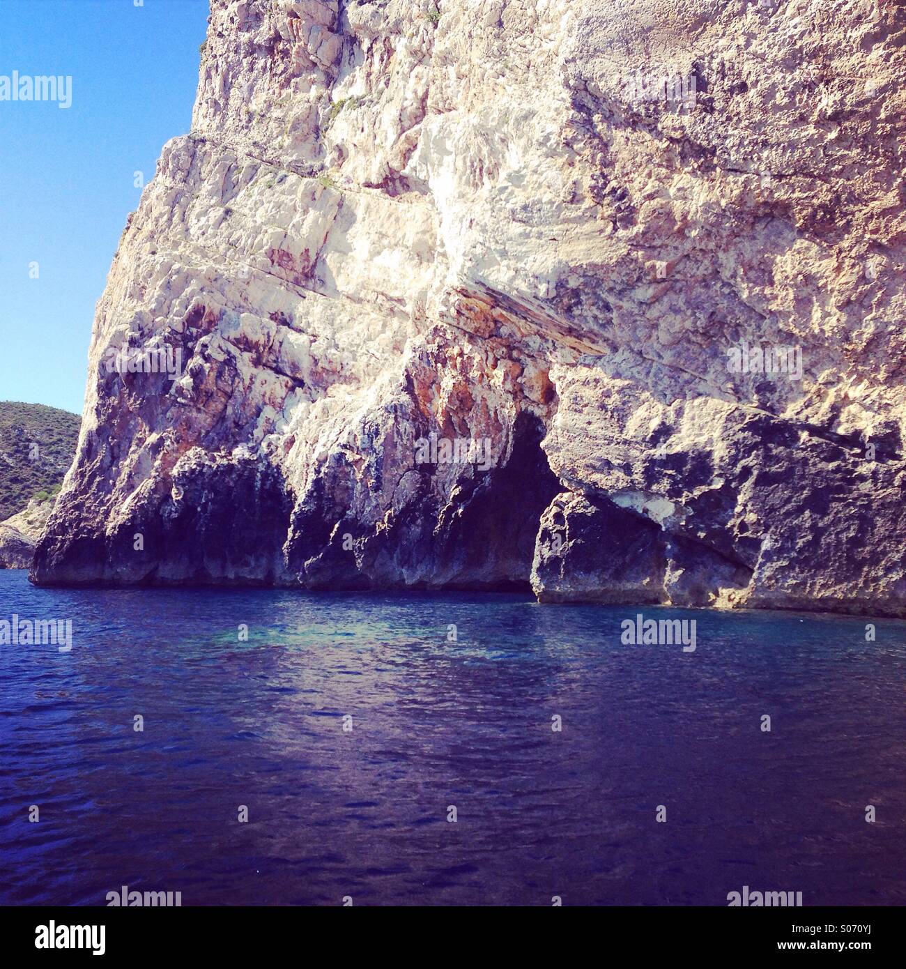 Big cliff rock and blue sea Stock Photo - Alamy