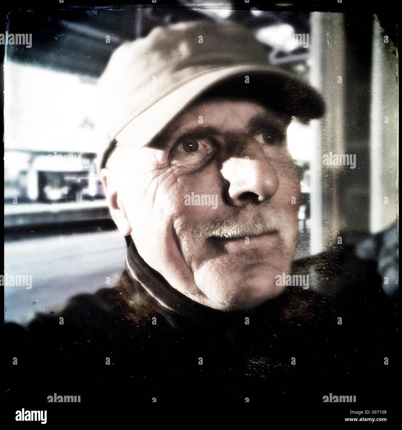 A man in a cap smiling Stock Photo - Alamy