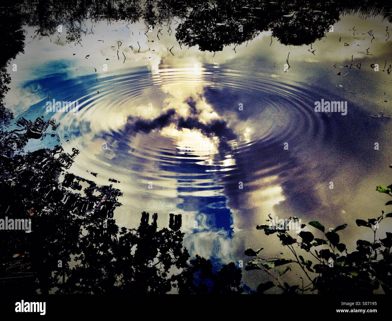 Ripple in pond and reflected sky Stock Photo - Alamy
