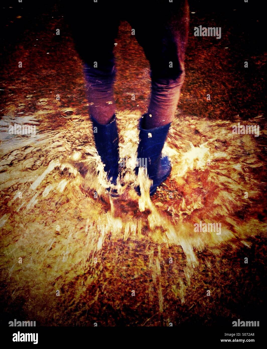 Young girl splashing in stream Stock Photo - Alamy