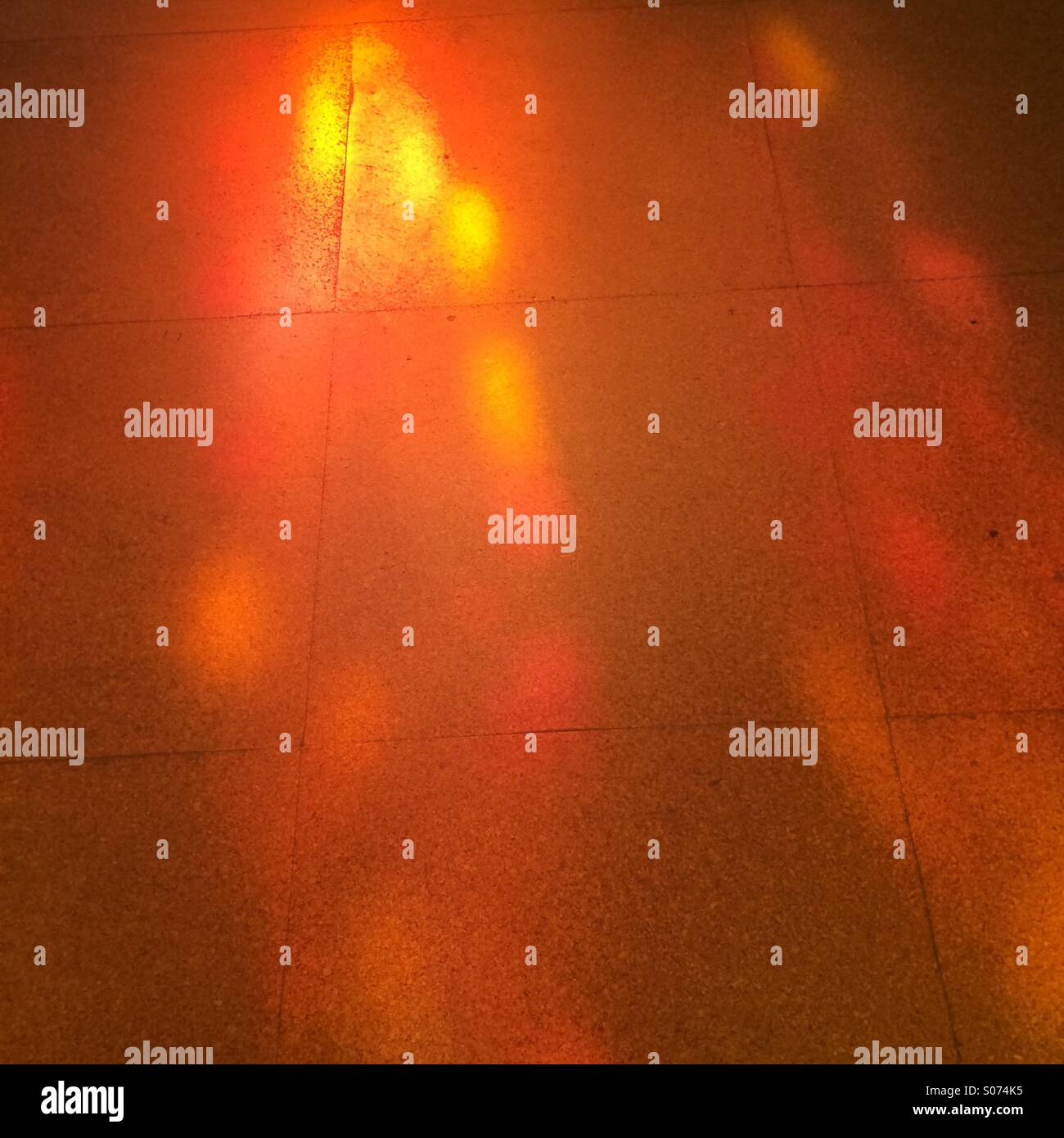 Orange and yellow illuminations from sunlight coming throu stained ...