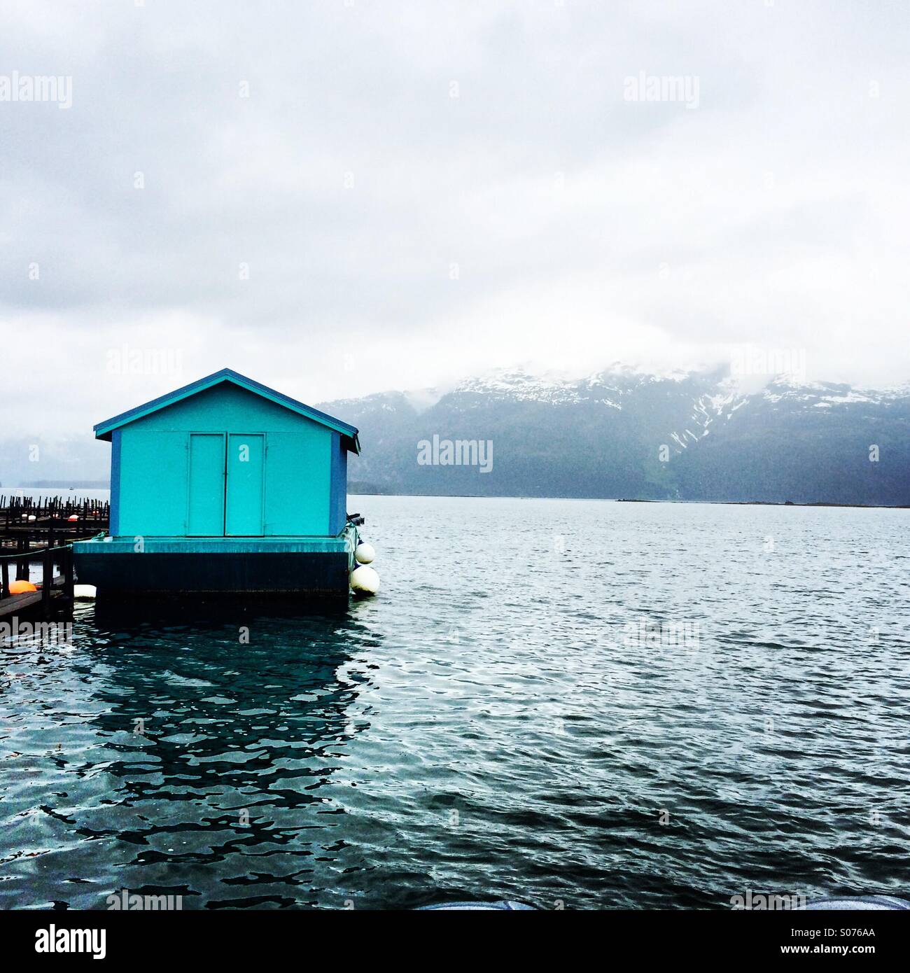 Blue house on ocean Stock Photo - Alamy