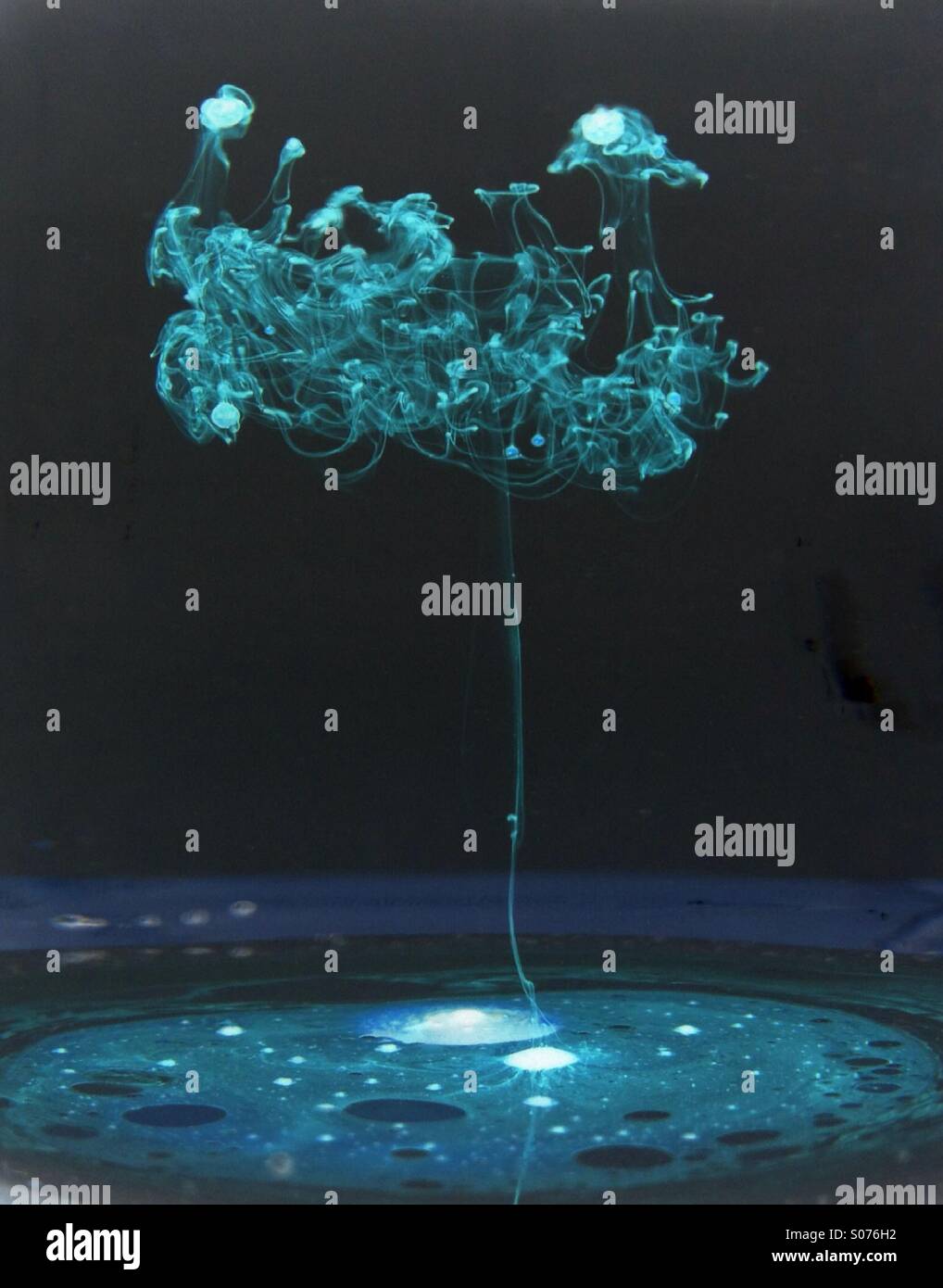 Colour inverted photo of oil mixing with water Stock Photo - Alamy