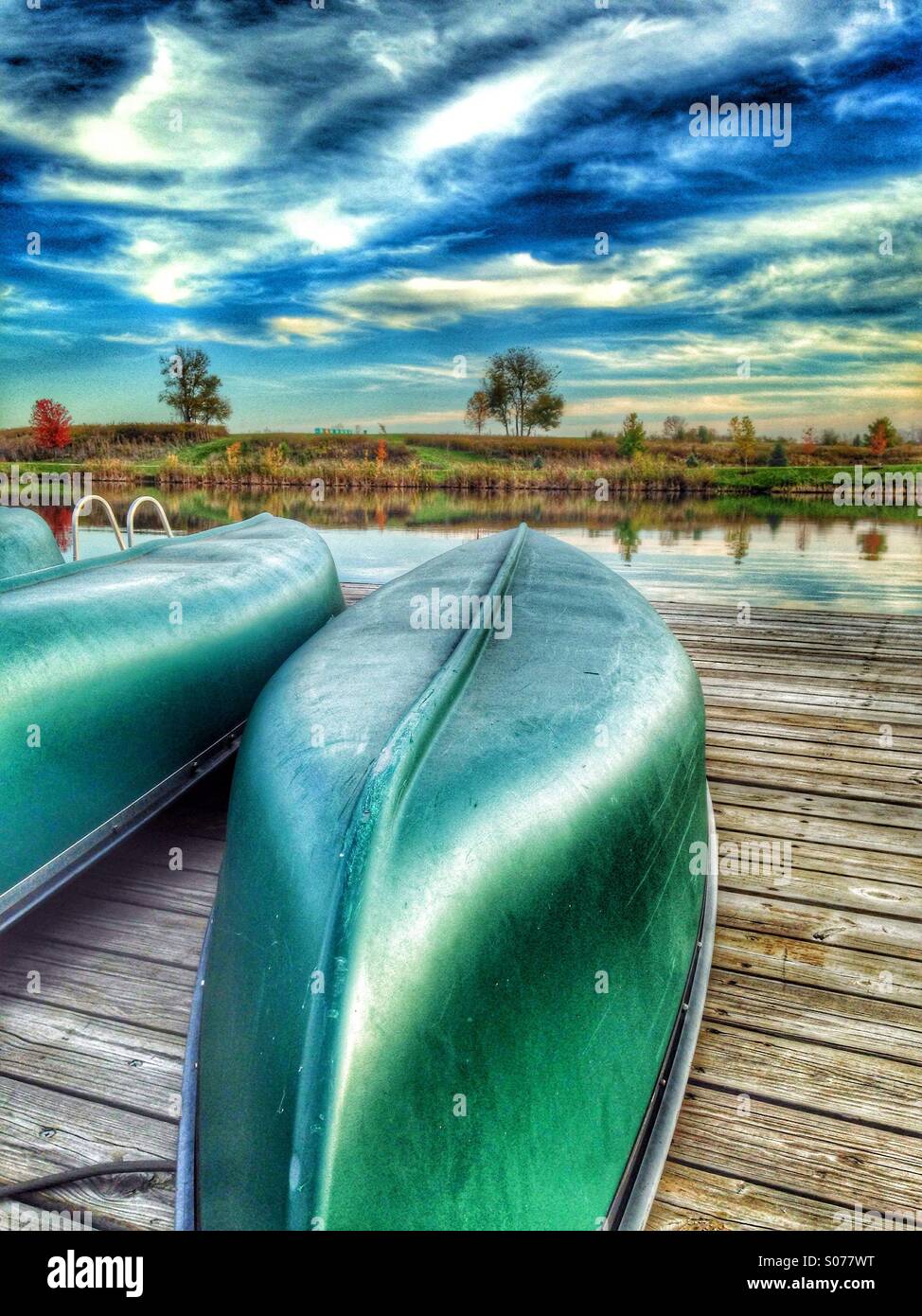 Green canoes at the lake Stock Photo - Alamy