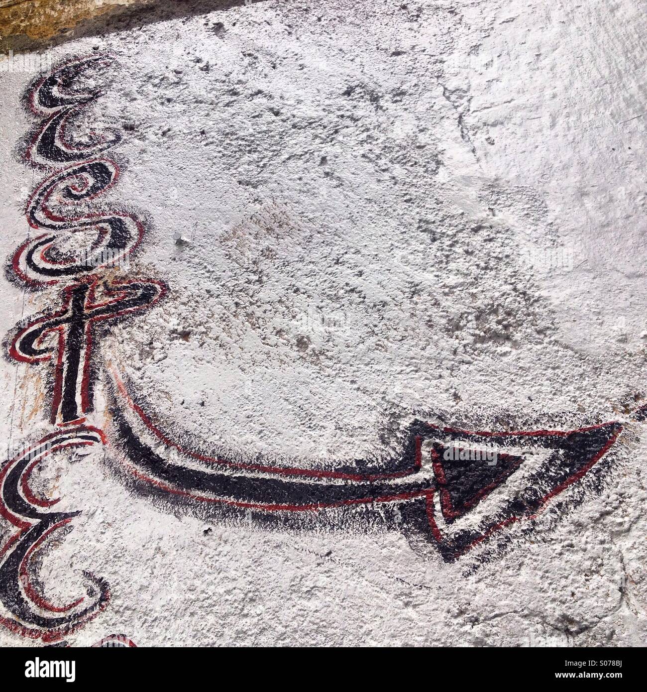 An arrow and the word "este", east in Spanish decorates a wall in ...