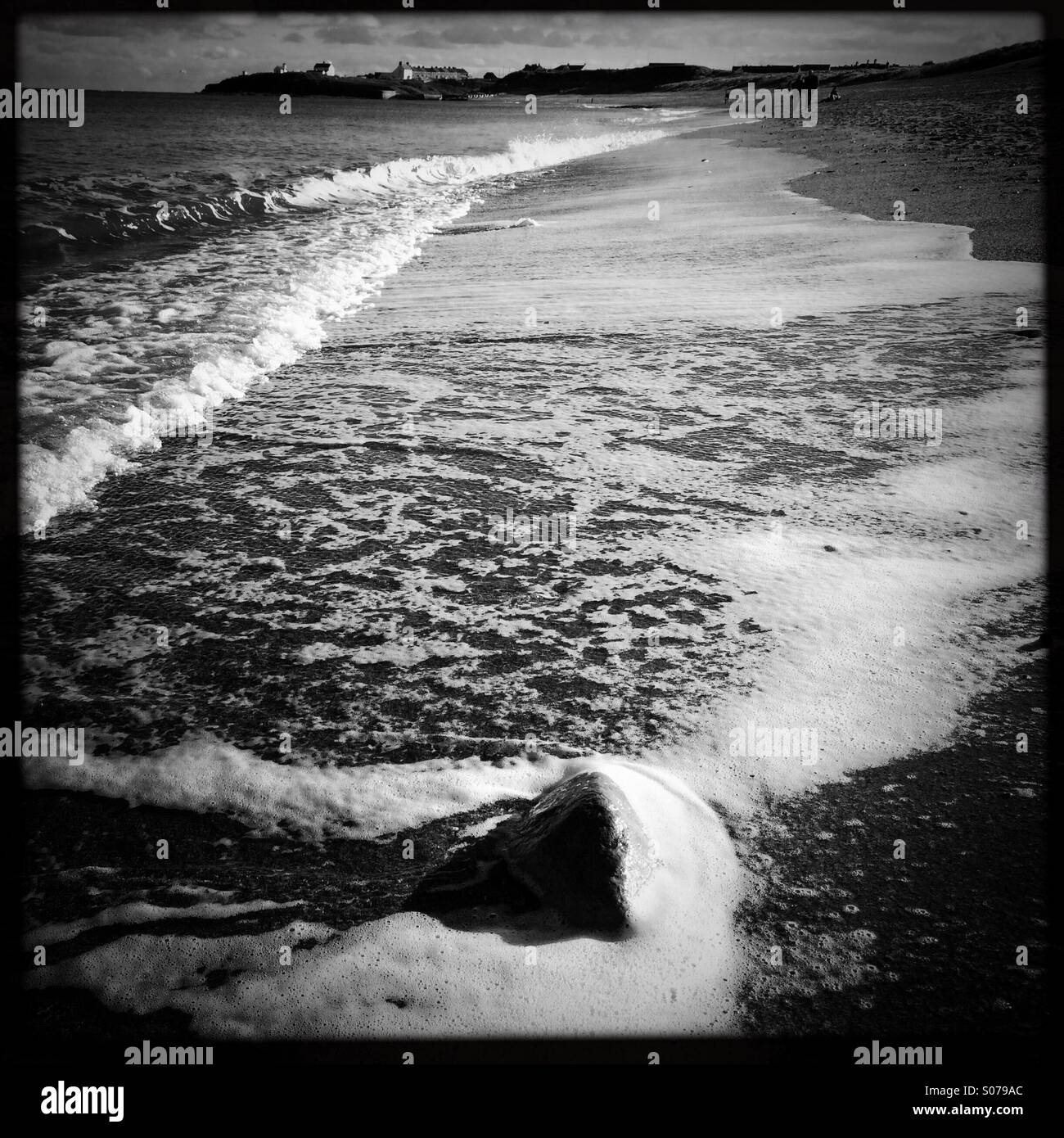 Waves lapping the beach Stock Photo - Alamy