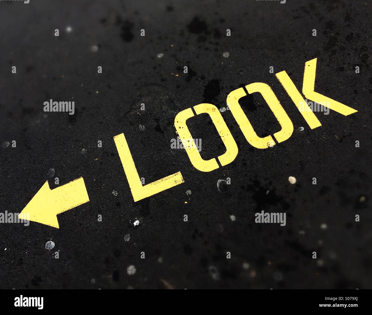 Look warning on road crosswalk Stock Photo - Alamy