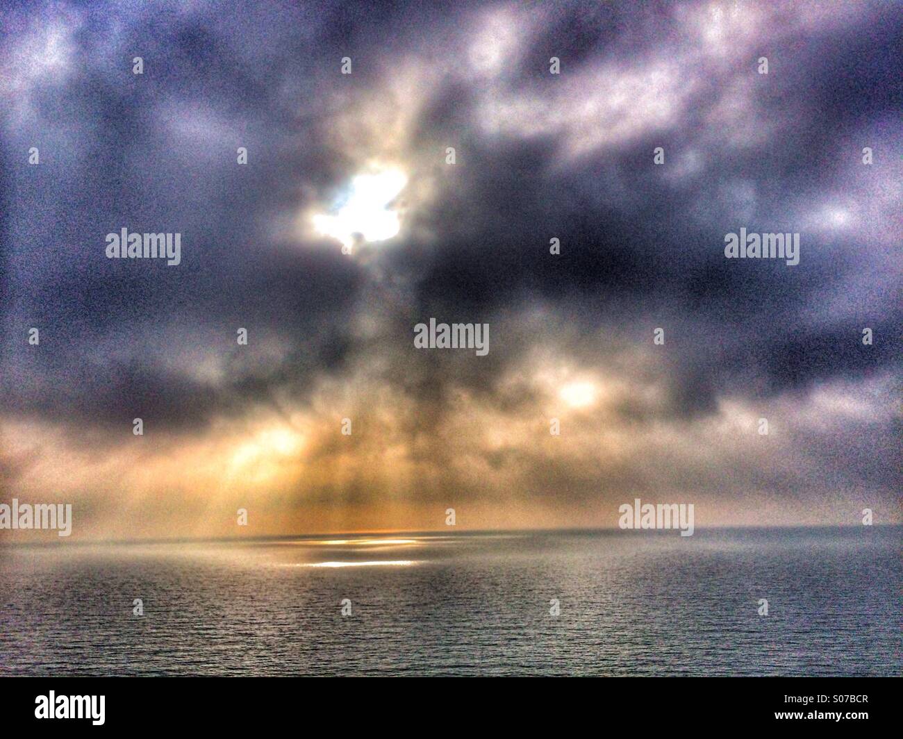 Sun rays over sea Stock Photo - Alamy