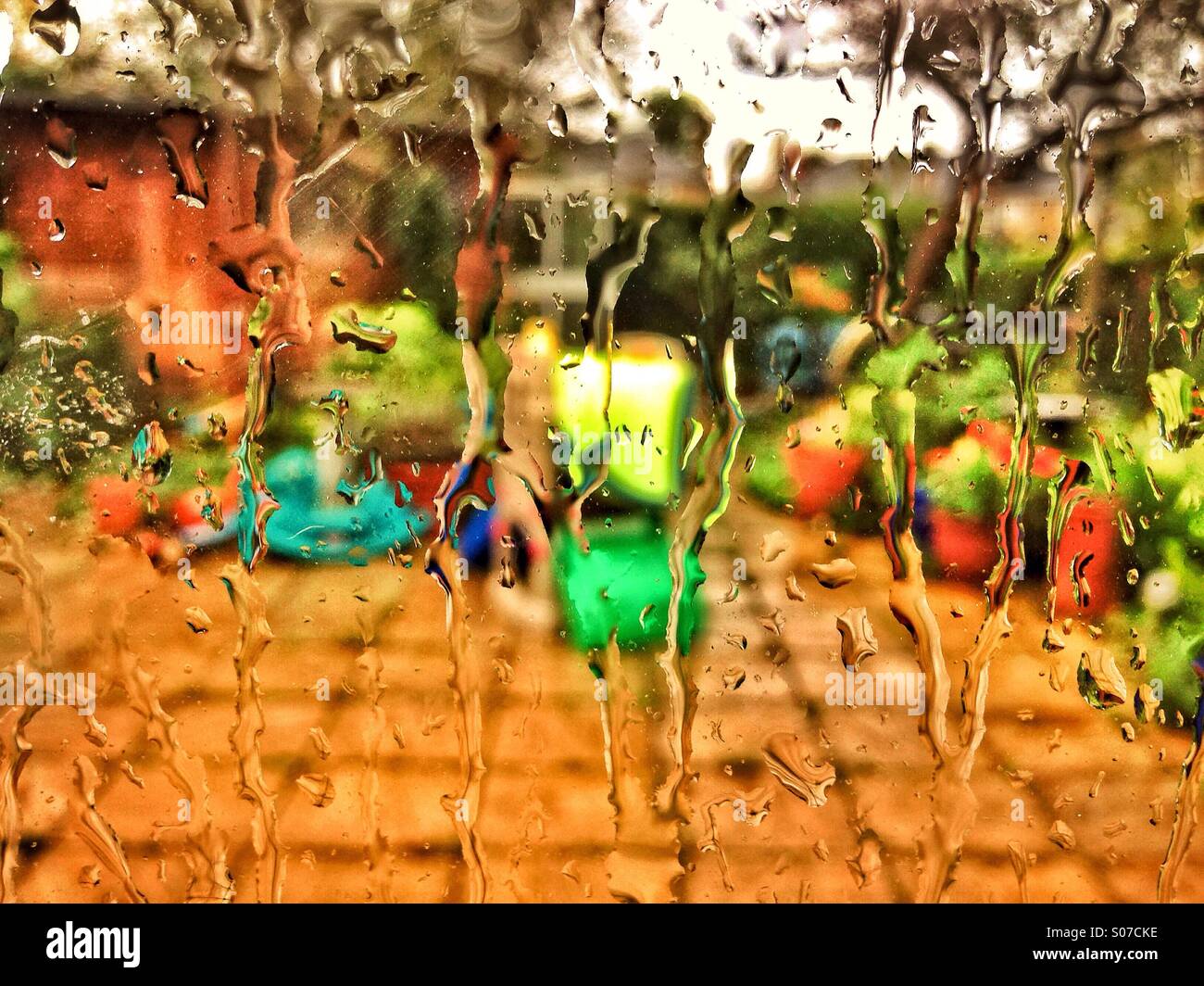 Rainy garden window Stock Photo - Alamy