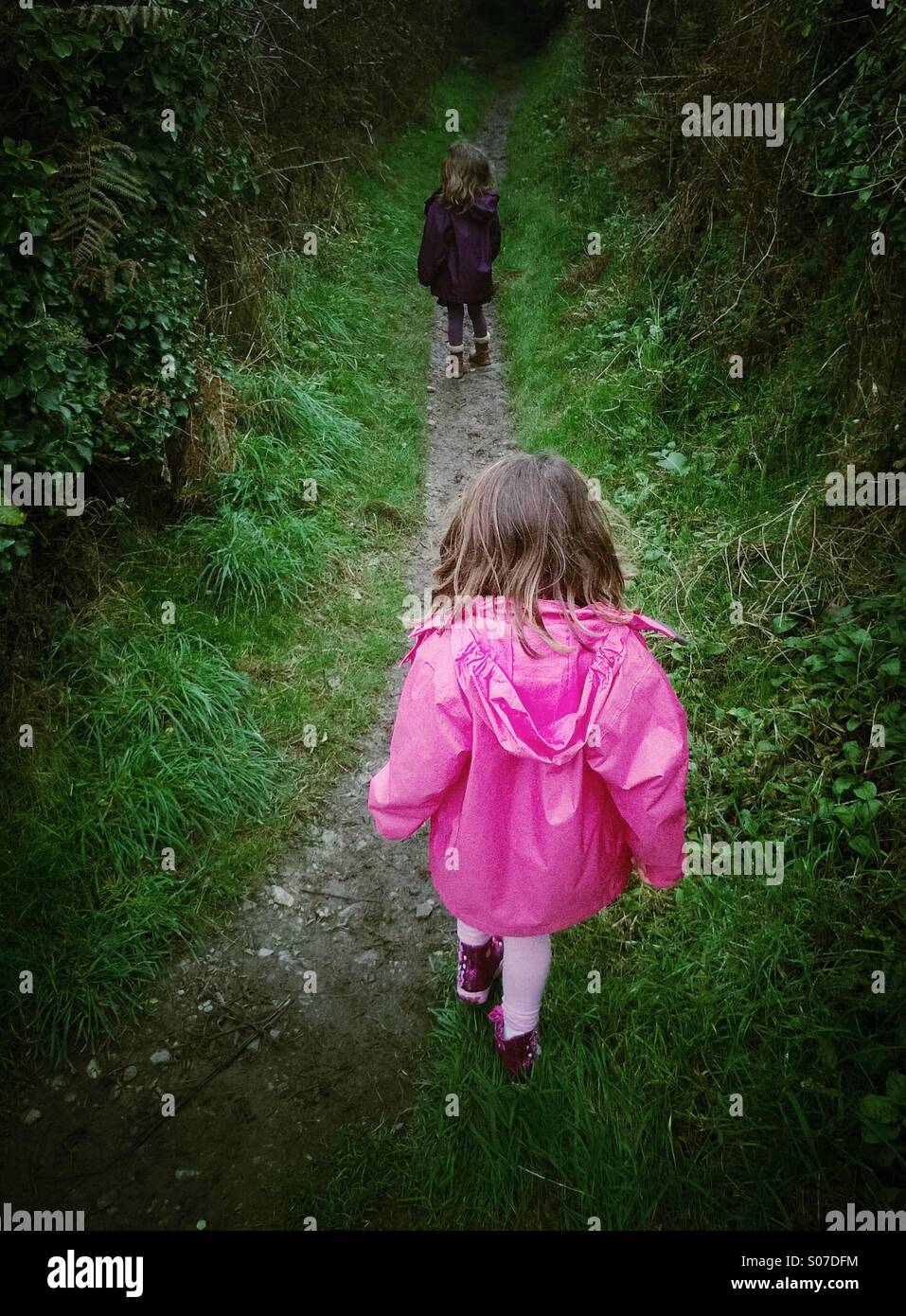 Two young girls walking along a countryside footpath Stock Photo - Alamy