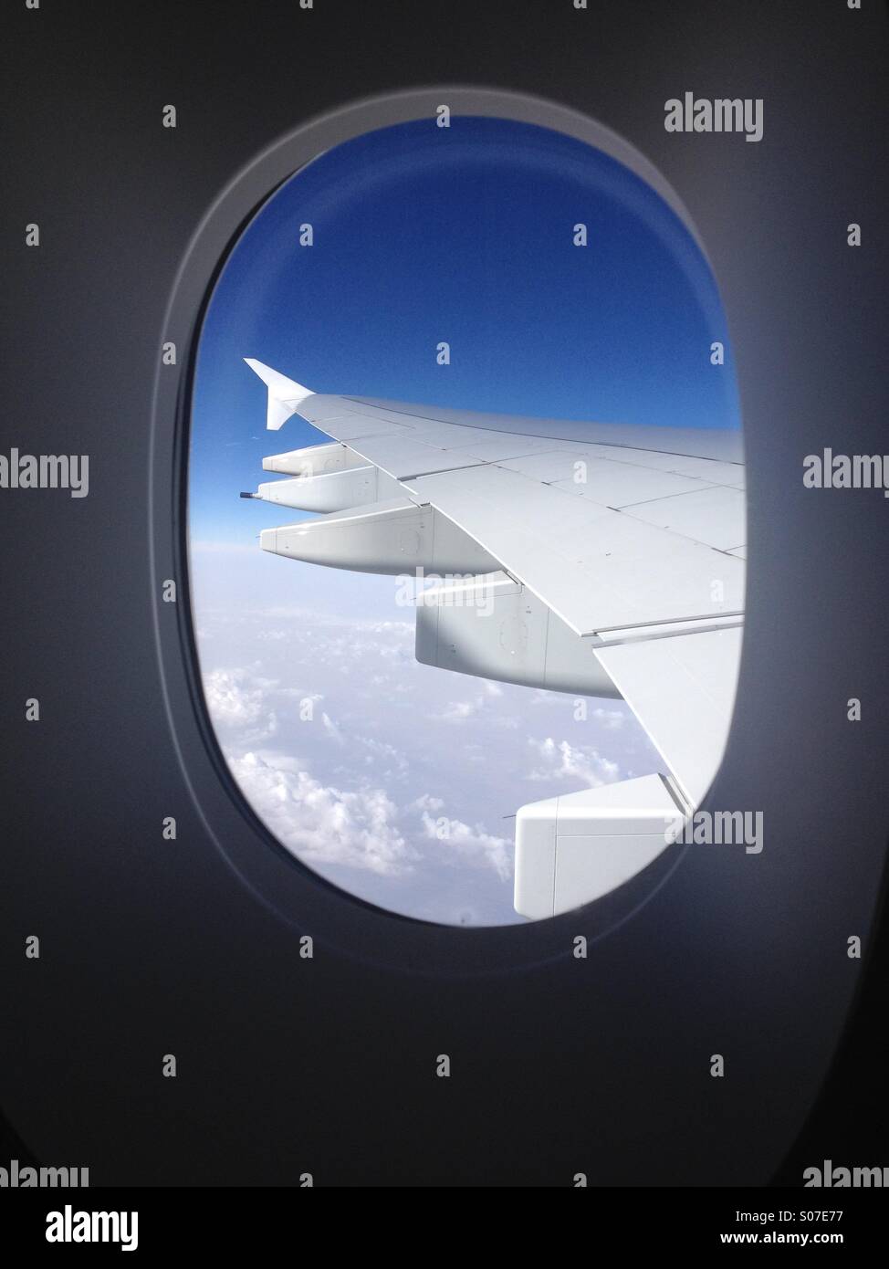 Wing shot through airplane window Stock Photo - Alamy