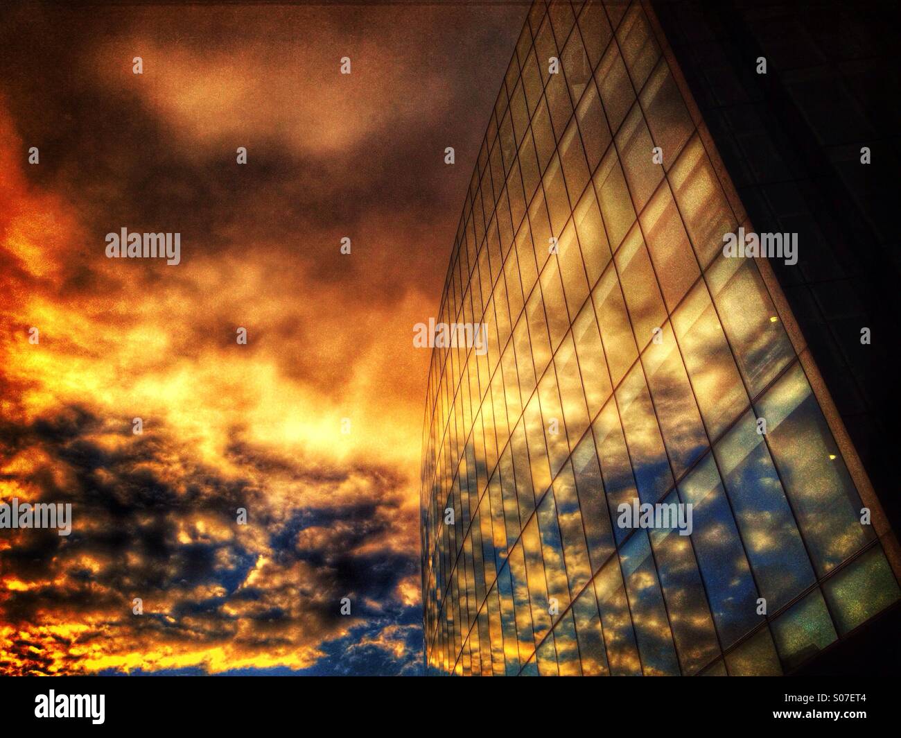 Sunset reflected in windows of office building Stock Photo - Alamy