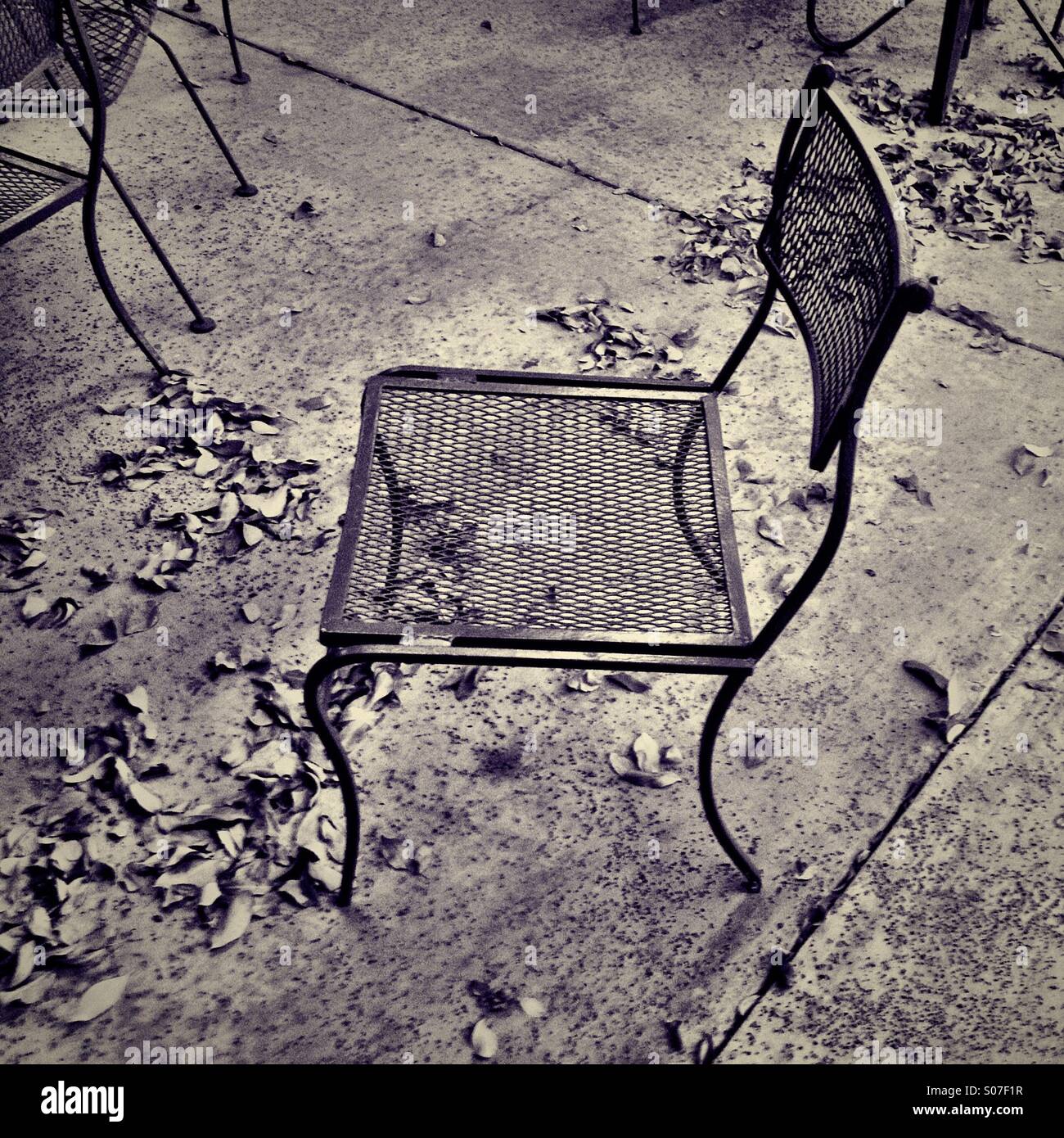 Autumn leaves fall around cafe patio chairs Stock Photo - Alamy