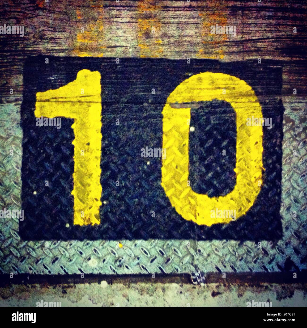 Number 10 in yellow color on a rough ground Stock Photo - Alamy