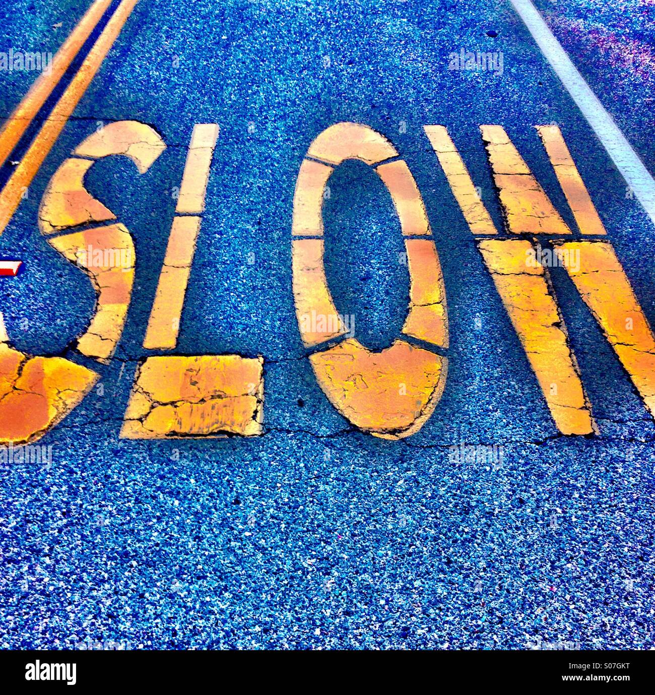 Slow road sign in yellow Stock Photo - Alamy