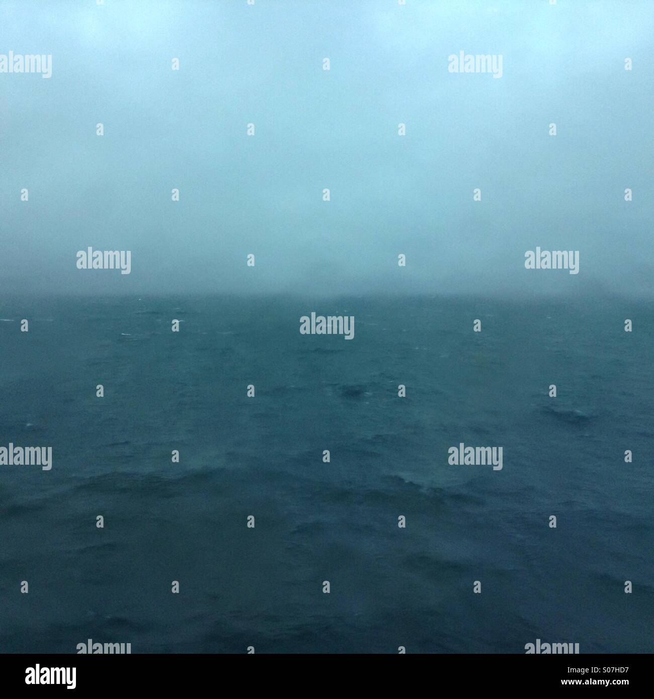 Rough sea in rain Stock Photo - Alamy
