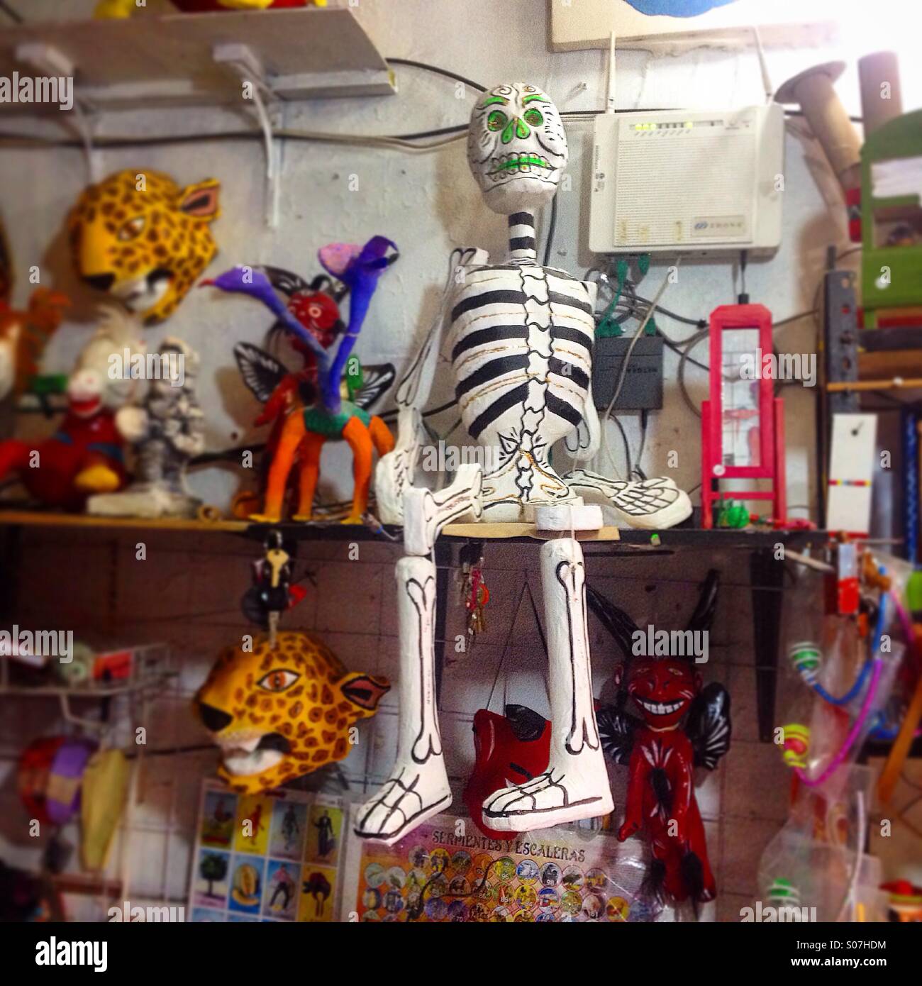 A paper mache skeleton sits on the shells of Taller Tlamaxcalli toy ...