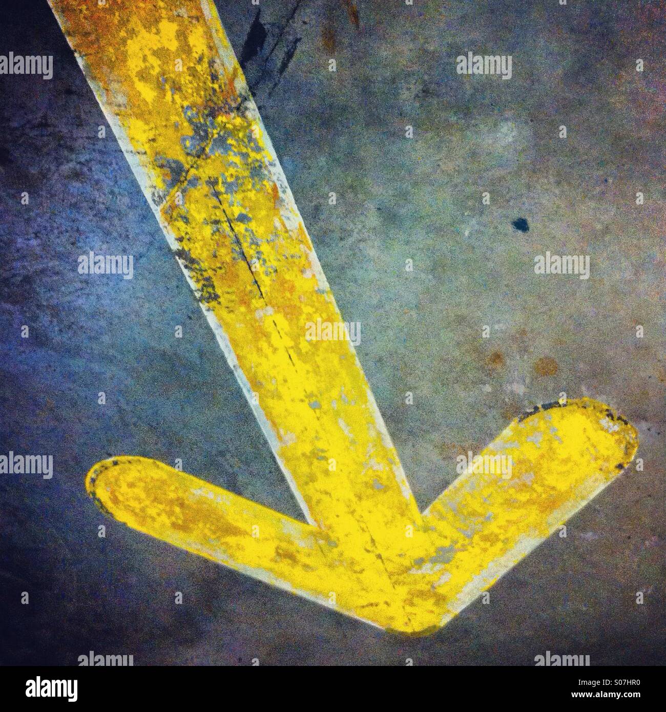 Yellow arrow going down Stock Photo - Alamy