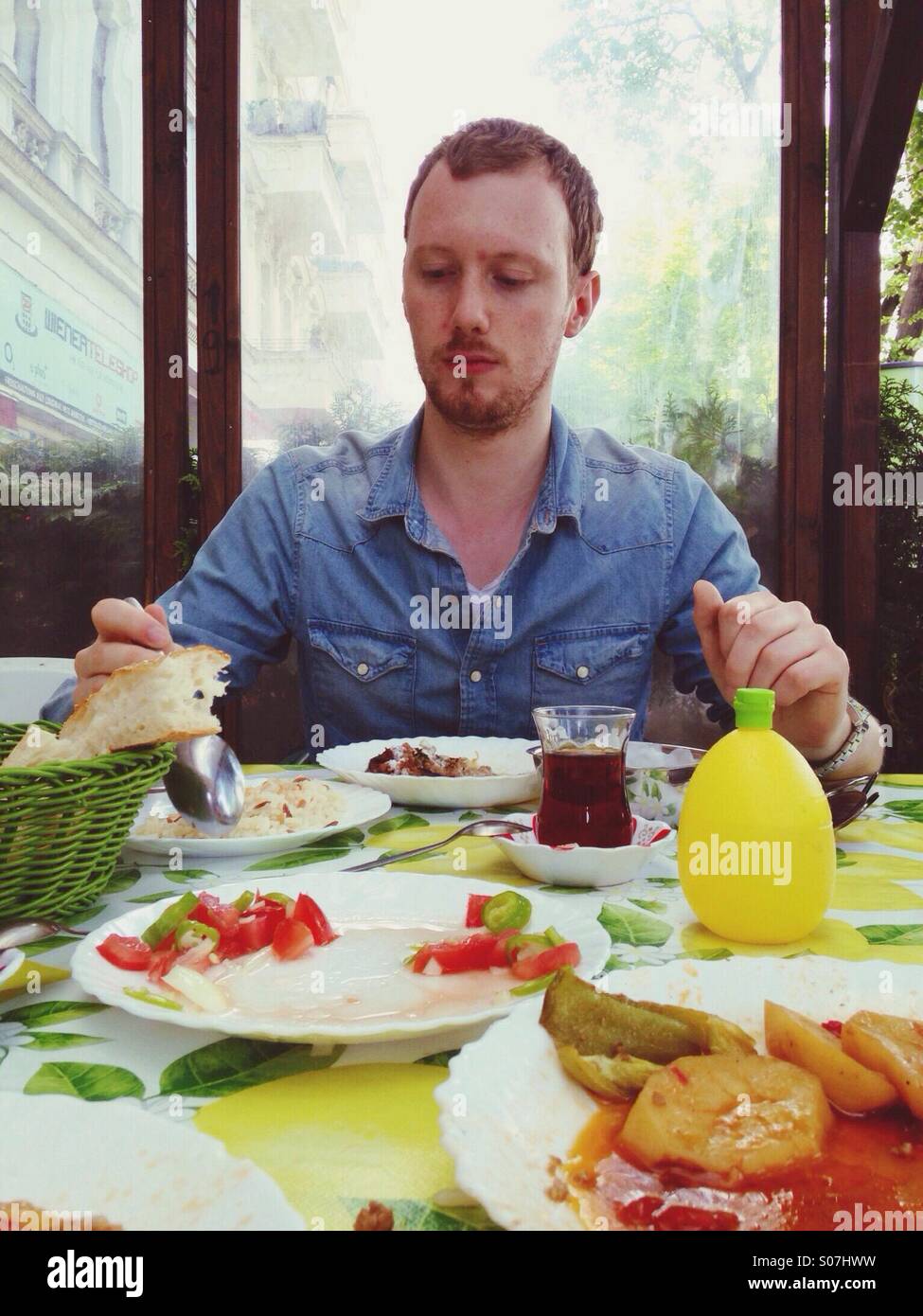 Man eating food at restaurant Stock Photo - Alamy