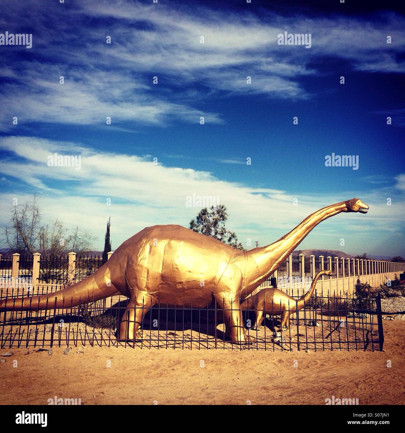 Gold dinosaur sculpture Stock Photo - Alamy