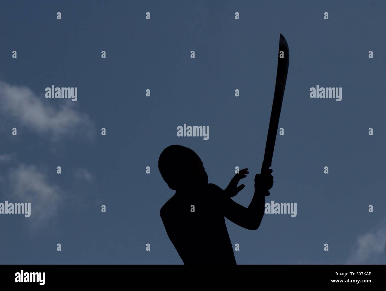 A small boy wielding a large machete in Dominican Republic Stock Photo ...