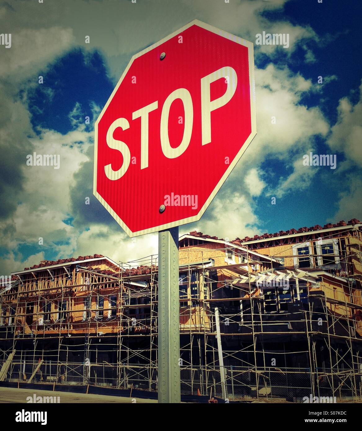 Ironic Stop Sign In Front Of New Construction Stock Photo - Alamy