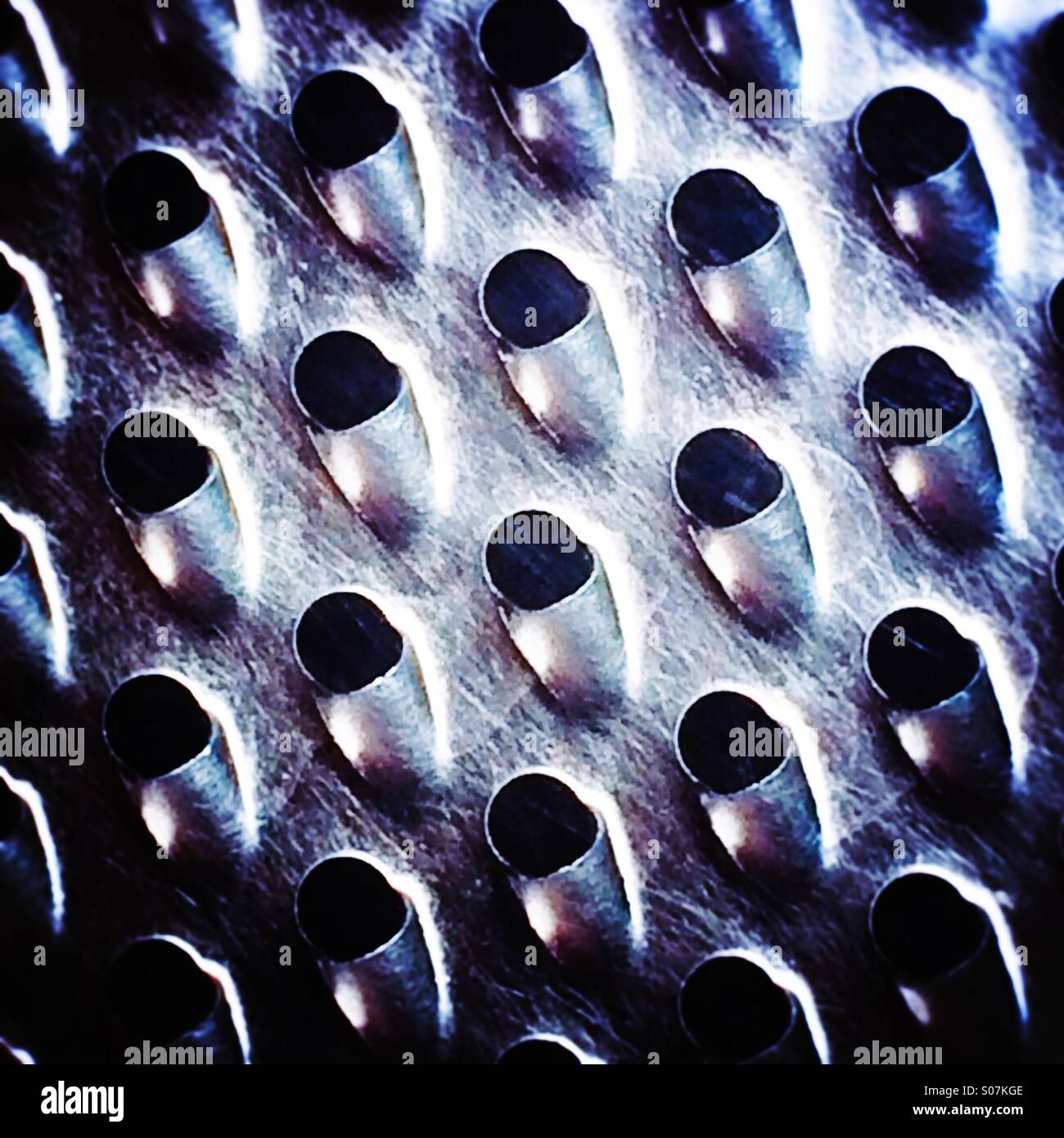 Holes on cheese grater Stock Photo - Alamy