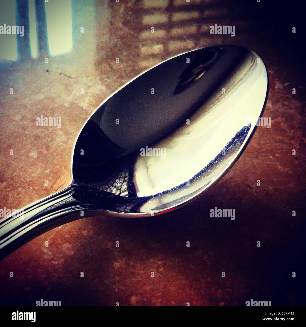 Close up of a detail of a spoon on a table Stock Photo - Alamy