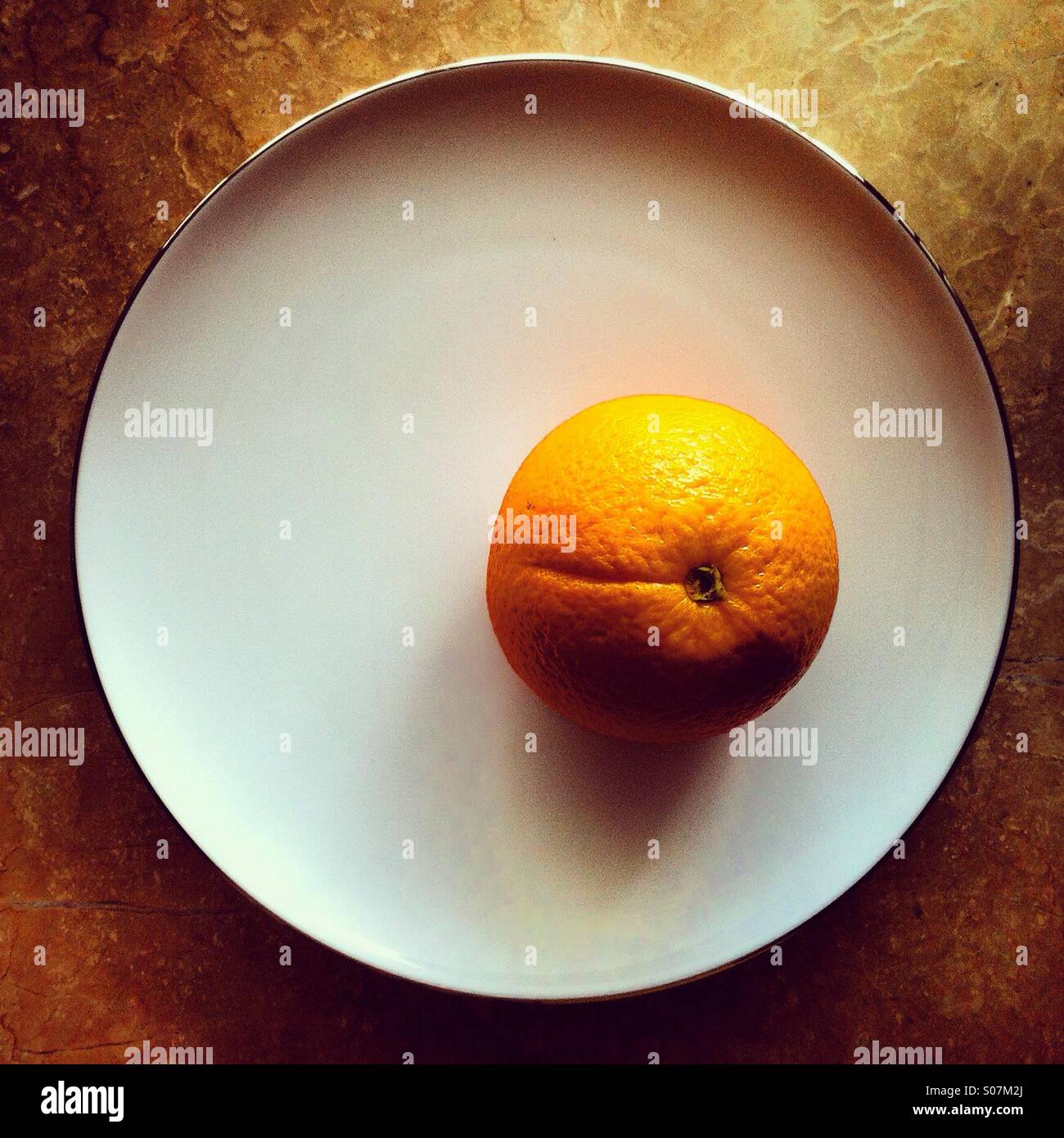 Orange fruit top view in a white plate Stock Photo - Alamy
