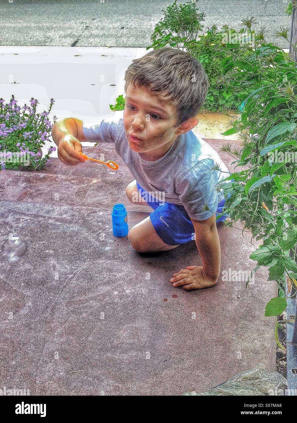Boy blowing bubbles hi-res stock photography and images - Alamy