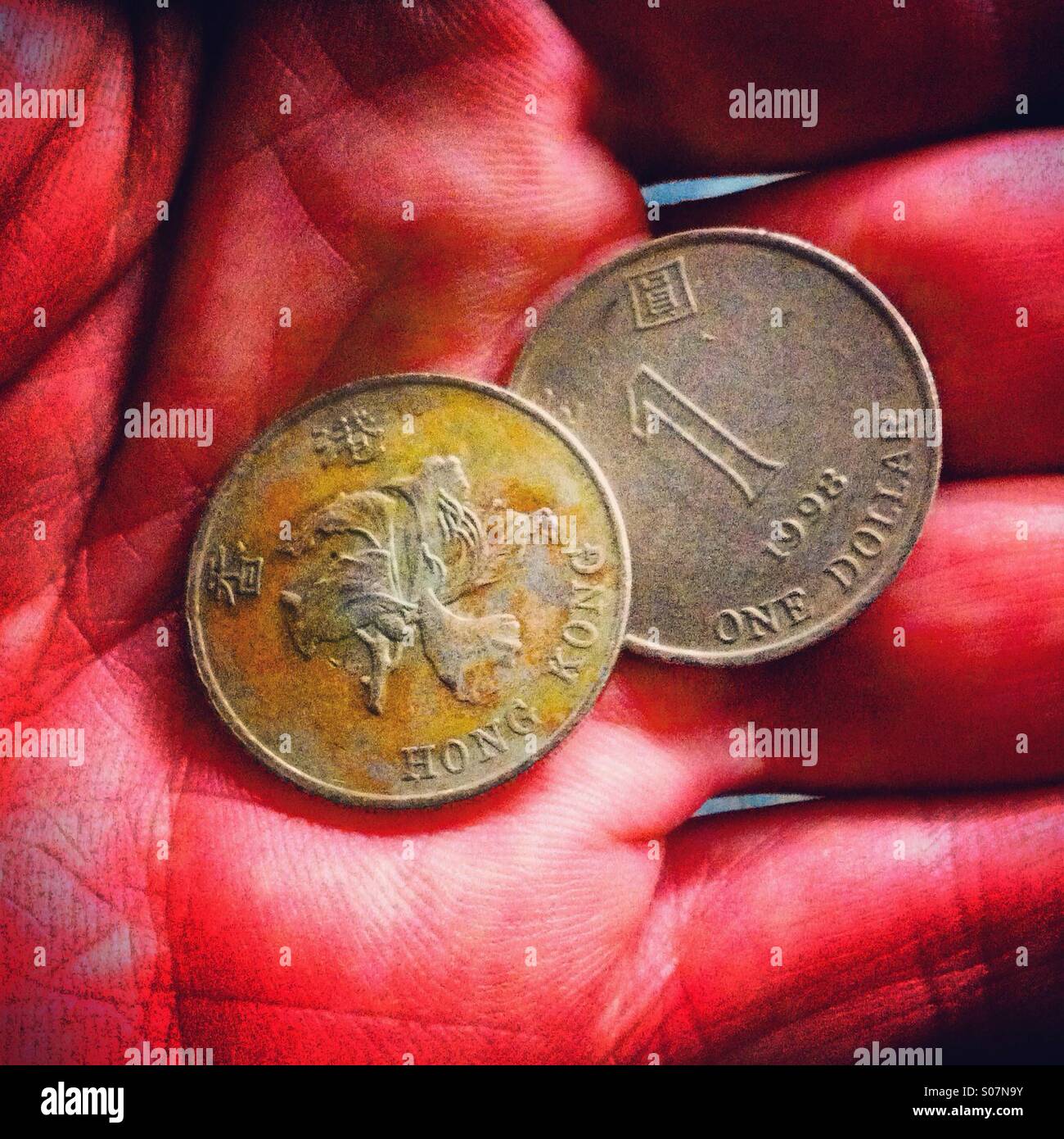 Coins in hand palm Stock Photo - Alamy