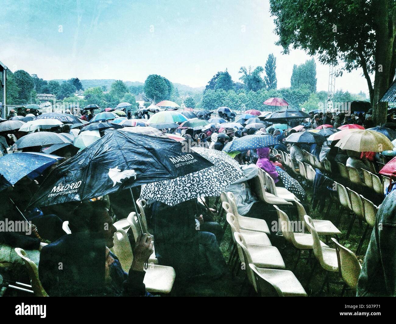 Spectators in rain with umbrellas during concert Stock Photo - Alamy