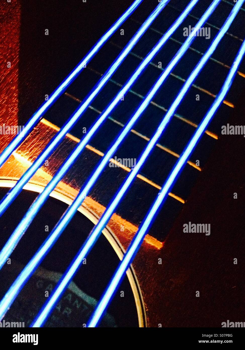 Acoustic guitar with electro luminescent wire representing strings ...