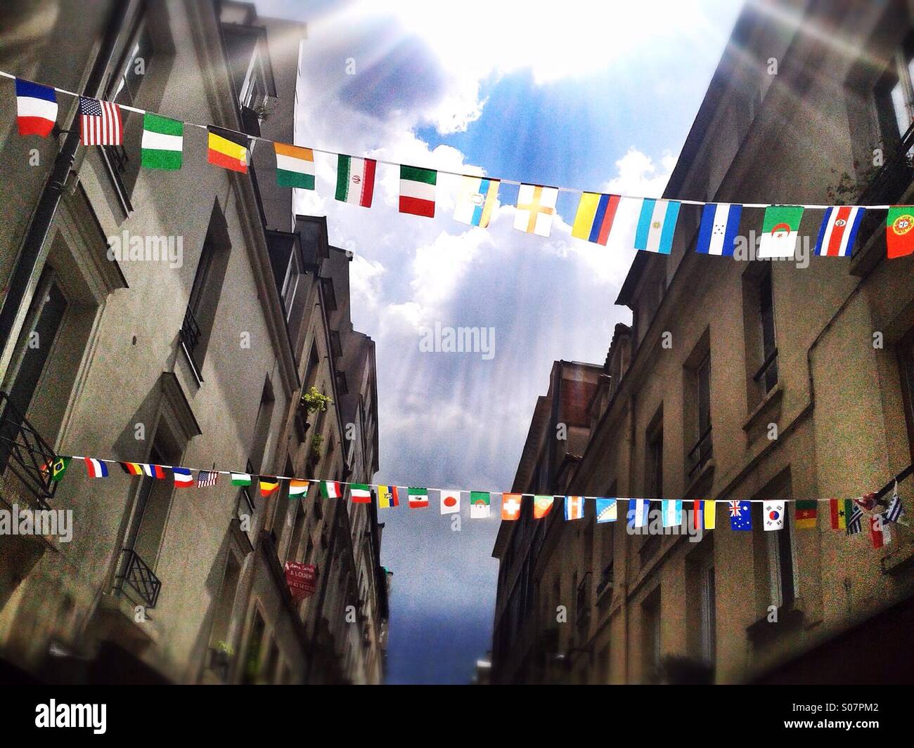 Flags of the world on festoon in Paris Stock Photo - Alamy