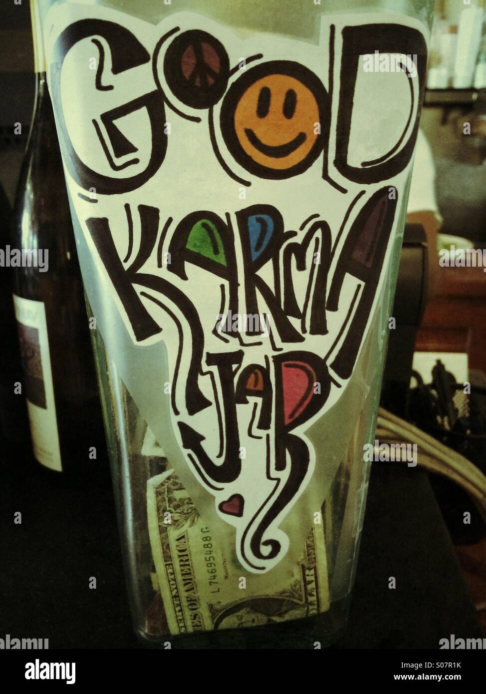 Tip jar on a restaurant countertop reads 'Good Karma Jar' Stock Photo ...