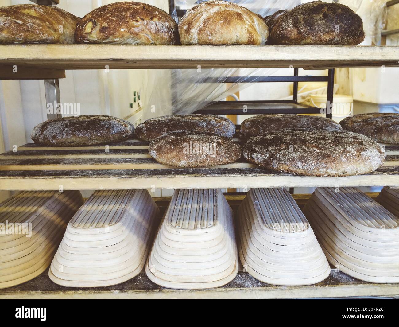 Freshly baked bread loaves cooling on rack at bakery in Sweden Stock ...