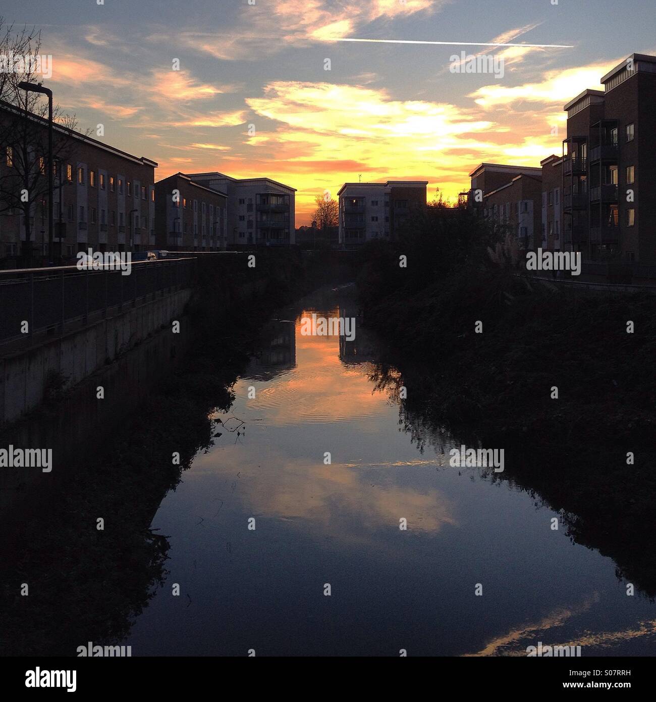 Urban river at dusk Stock Photo - Alamy