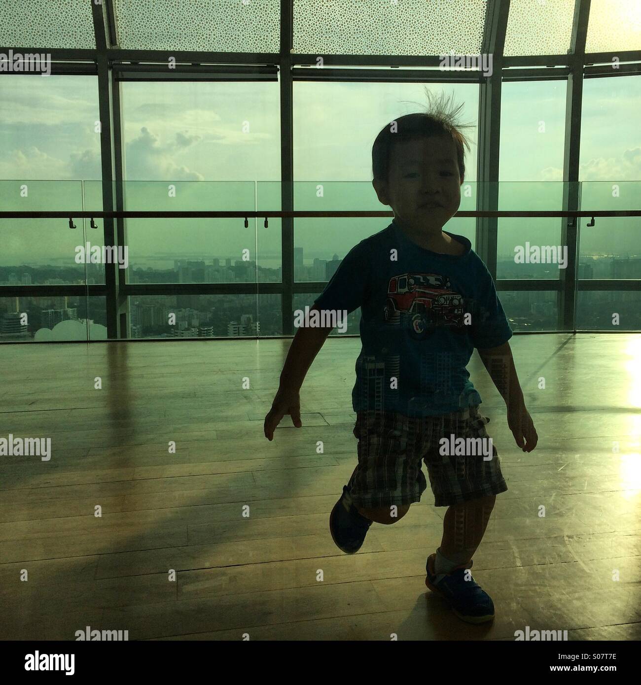 Boy is running around with sunlight in the background Stock Photo - Alamy