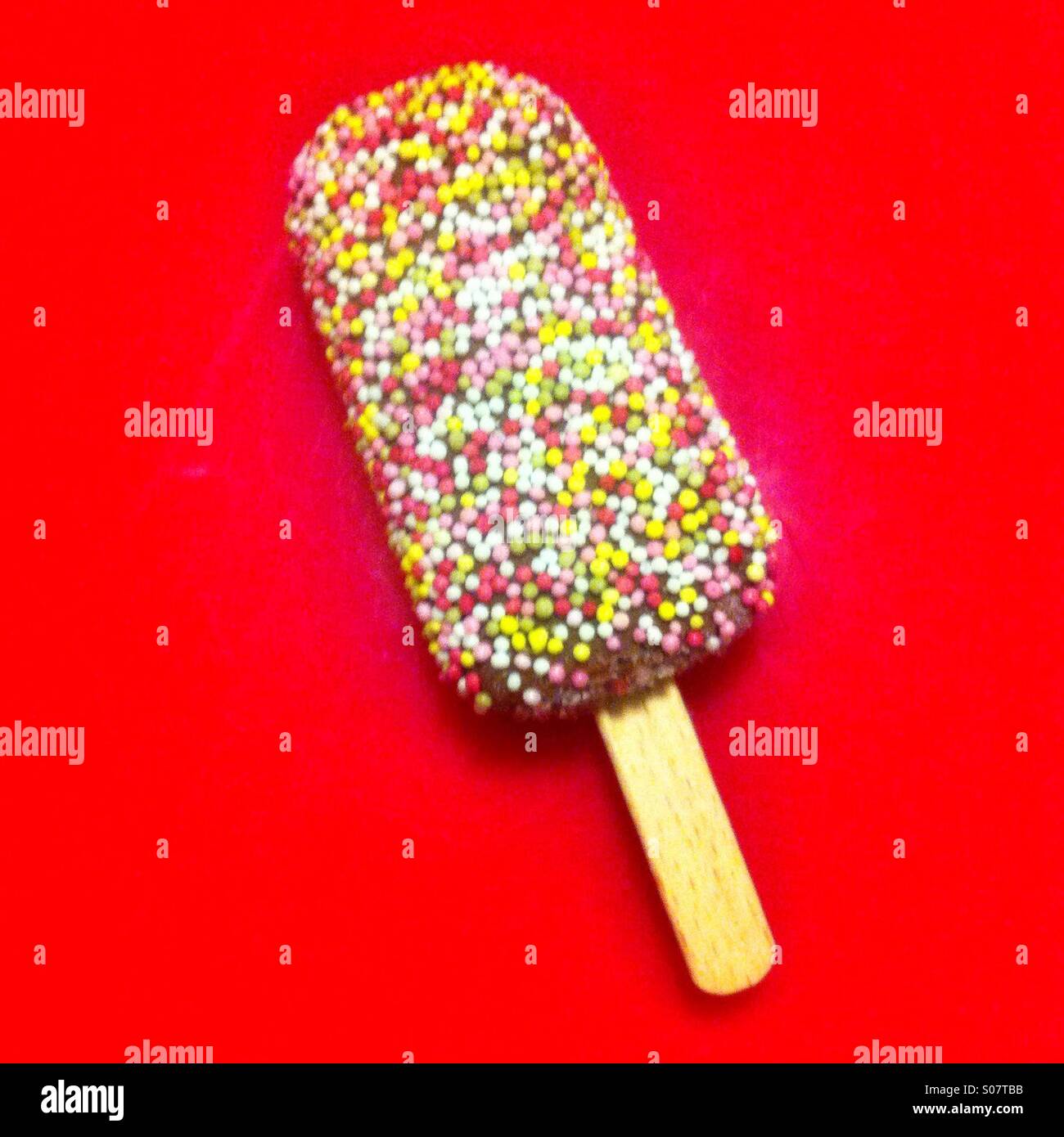 Frozen ice cream lolly pop on a red background Stock Photo - Alamy