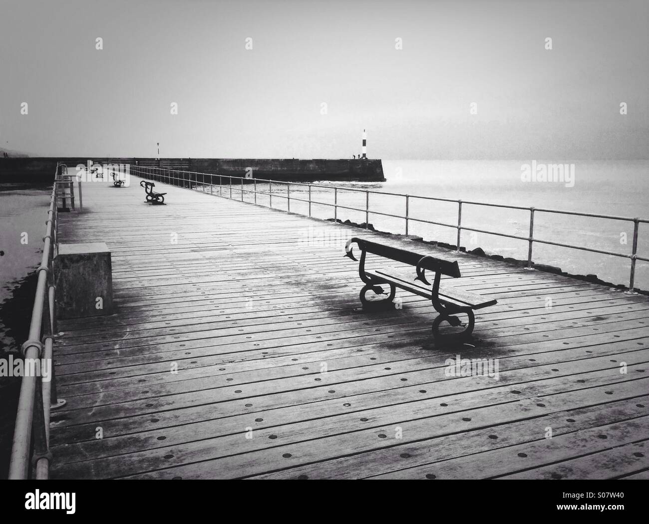 An empty promenade in a harbour Stock Photo - Alamy