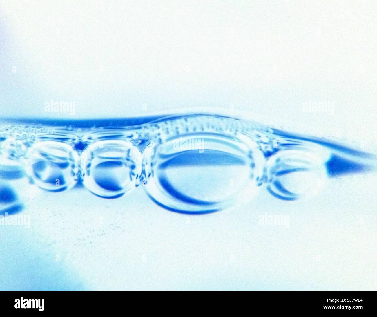 Colour inverted bubbles on water Stock Photo - Alamy
