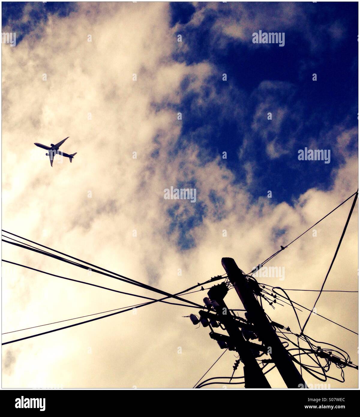 An airplane flying over urban area Stock Photo - Alamy