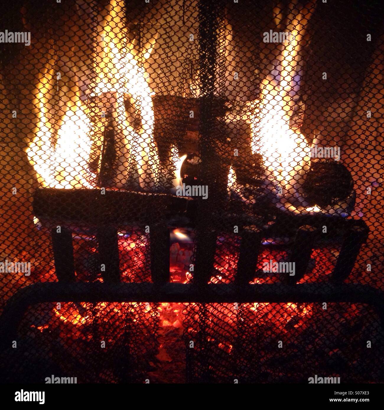 Logs burning in a fireplace Stock Photo - Alamy