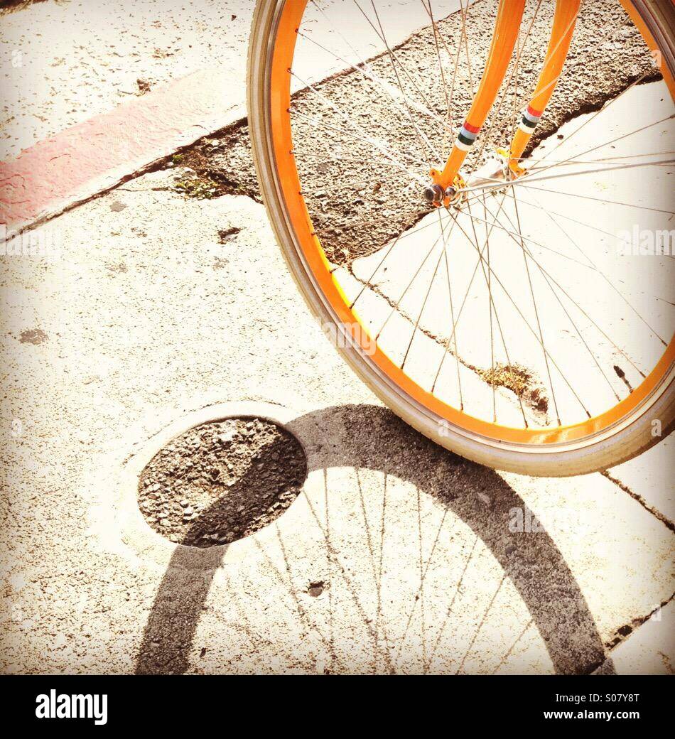 Bicycle wheel and shadow Stock Photo - Alamy