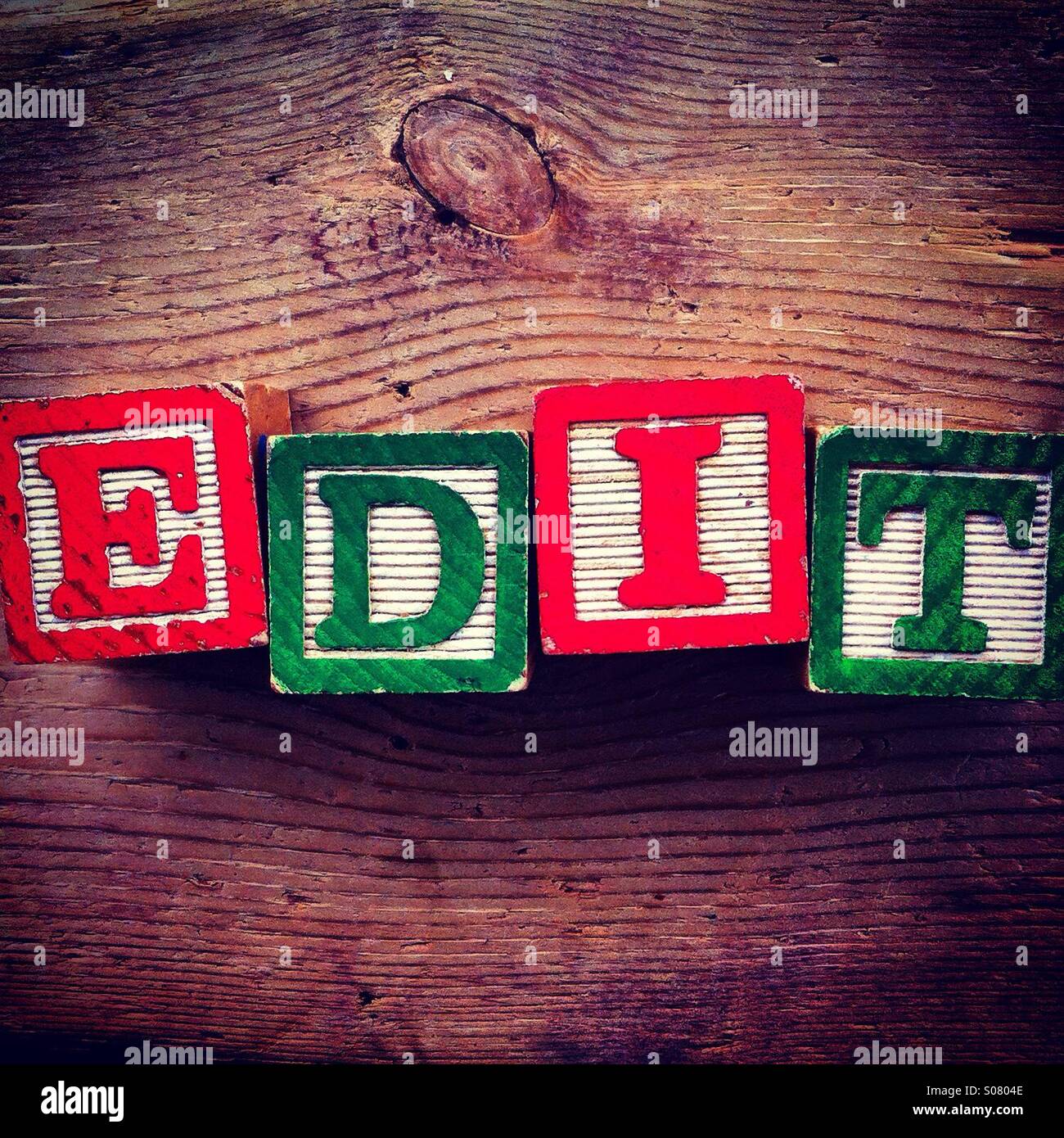 Word EDIT done with wood blocks on a woody background Stock Photo - Alamy