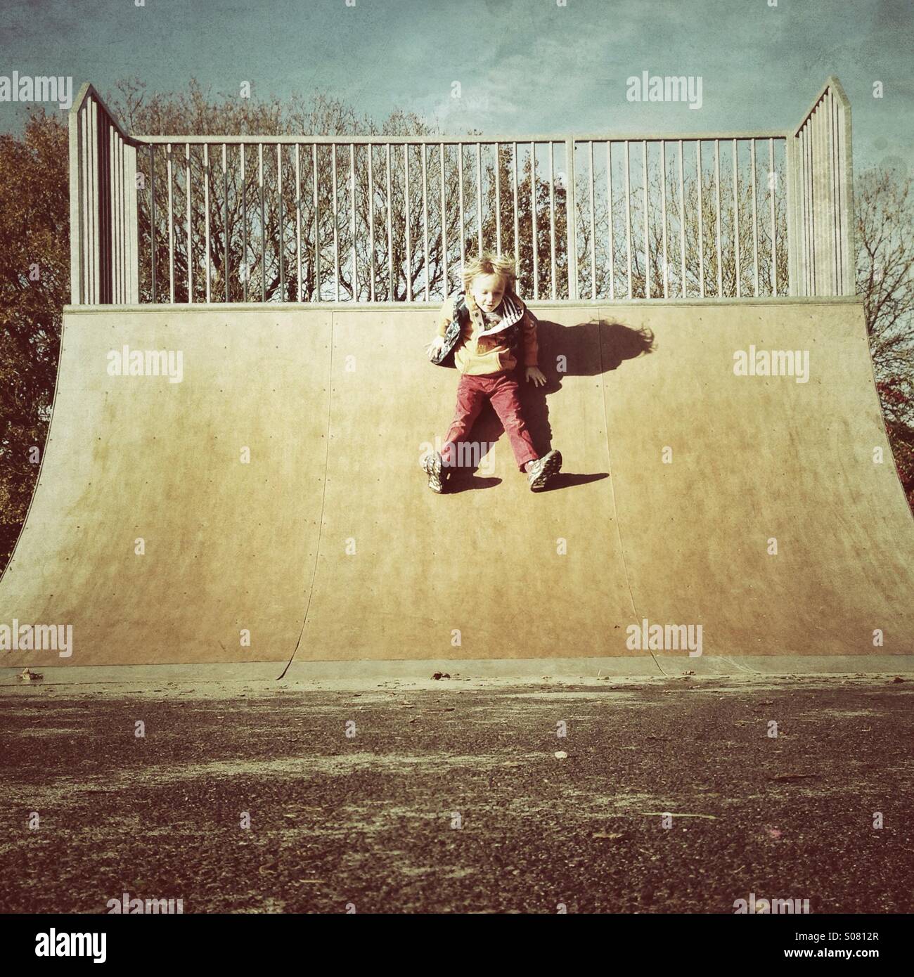 Sliding down a skate ramp Stock Photo - Alamy
