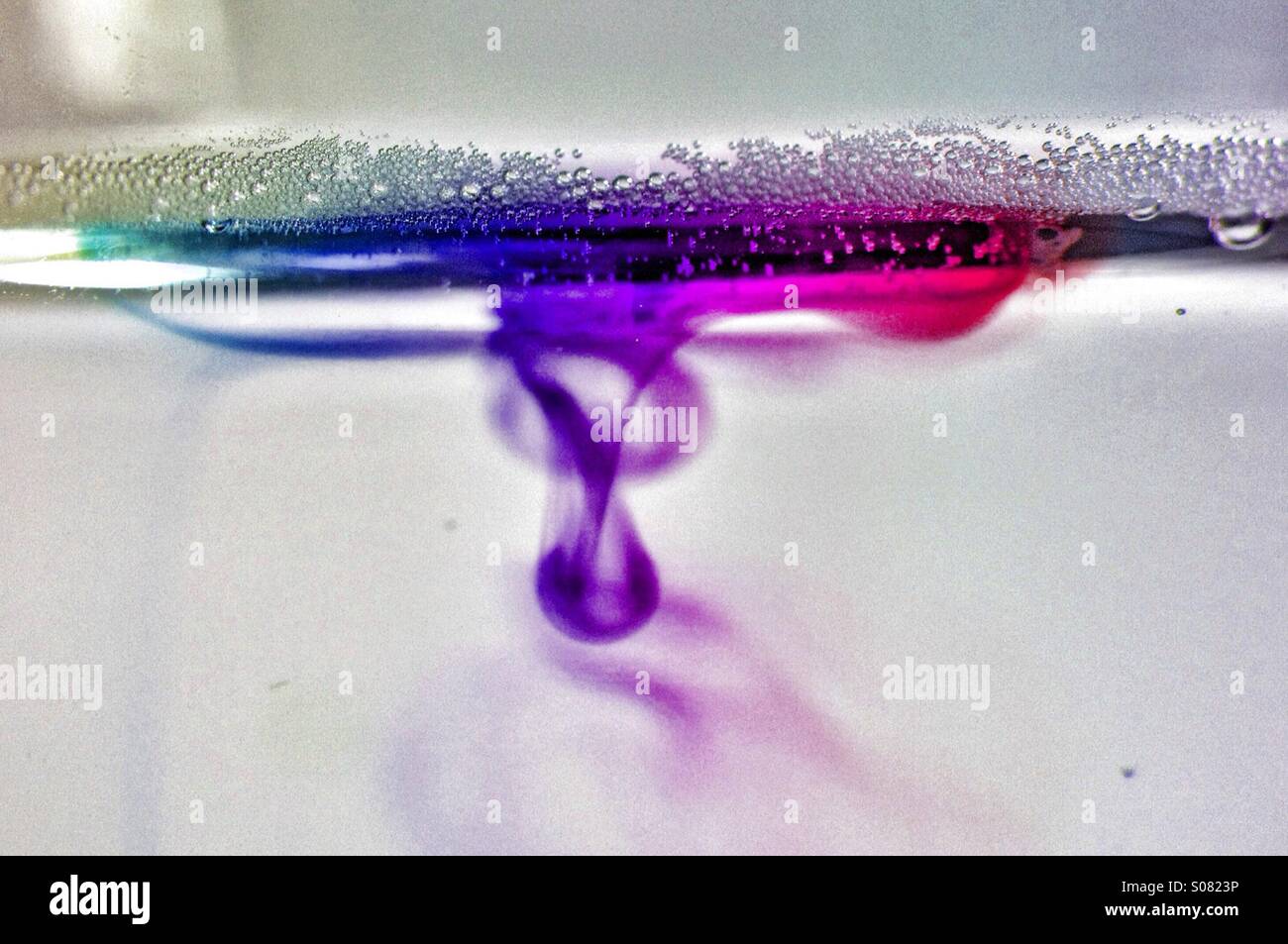 Coloured water mixing with clear water Stock Photo - Alamy