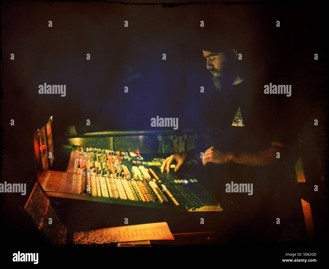 Sound engineer at work behind a mixing table during a live concert ...