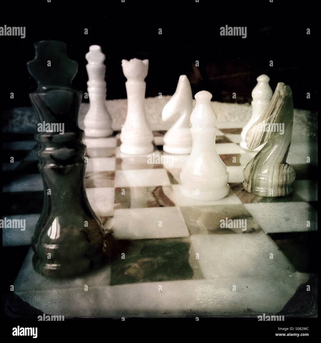 Chess pieces on a stone chess board Stock Photo - Alamy