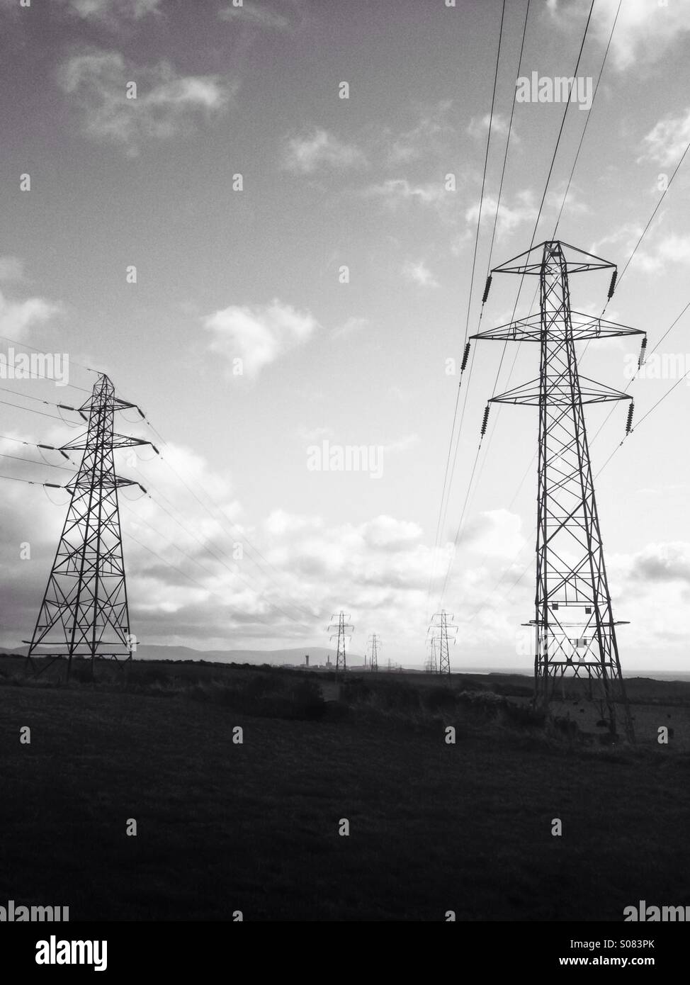 Electricity pylons leading off into the distance with sellafield in the ...